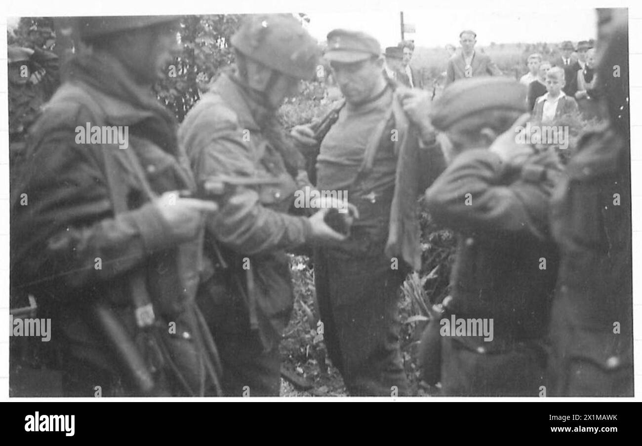 Captured German soldiers are inspected by Allied forces following the ...