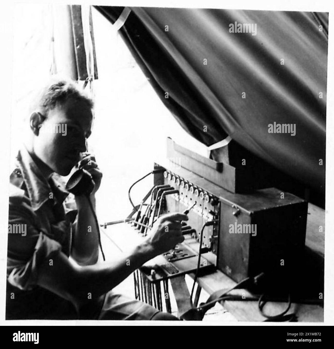 Signalman E.T. Munn operates a ten-line universal telephone set at ...