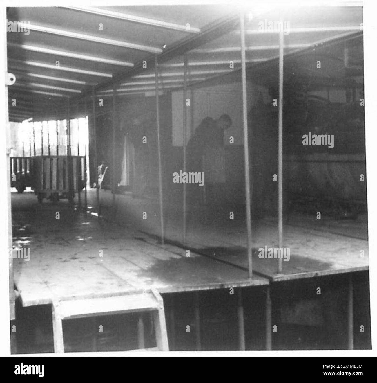 A British Army mobile laundry operates with trailers positioned side by ...