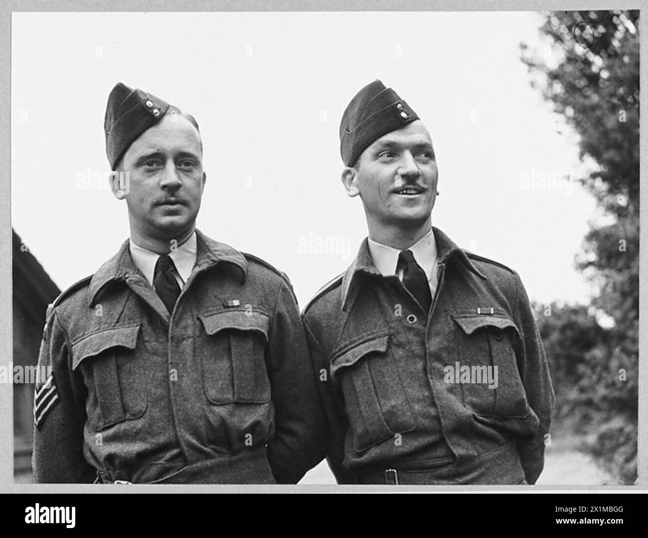 THE KING DECORATES R.A.F. MESS STEWARDS IN THE AIR - Two members of the ...