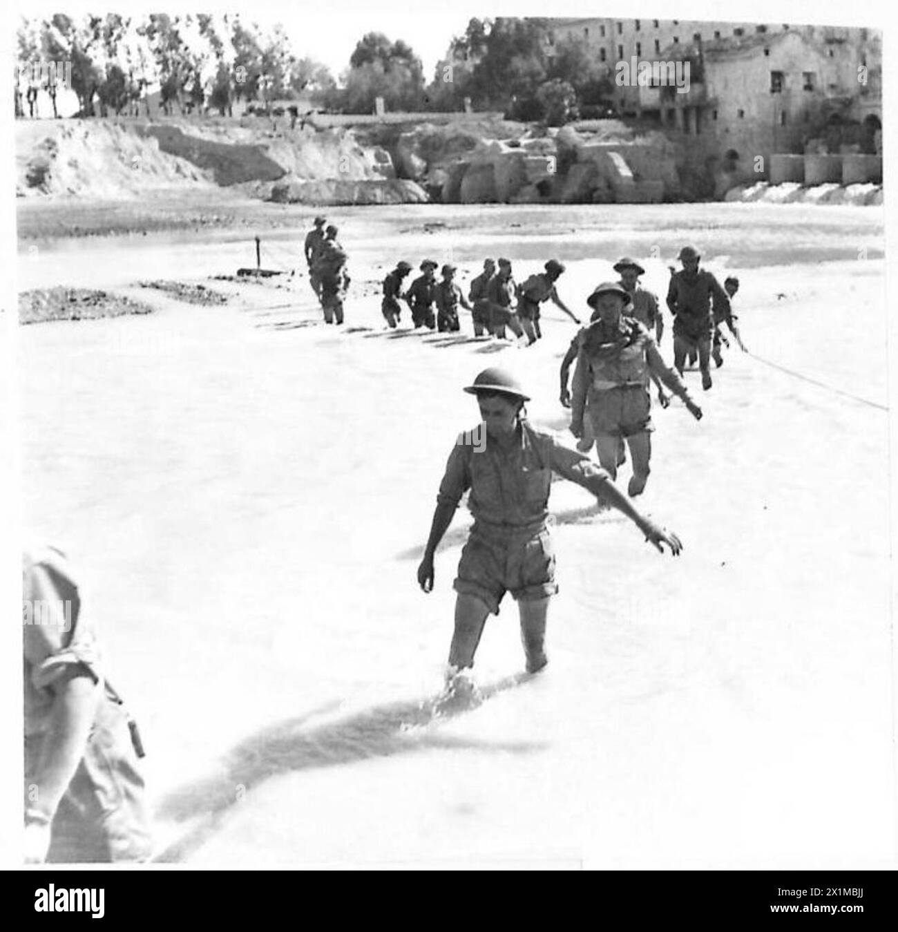 Members of a Reconnaissance Regiment of the 1st Division wade across a ...