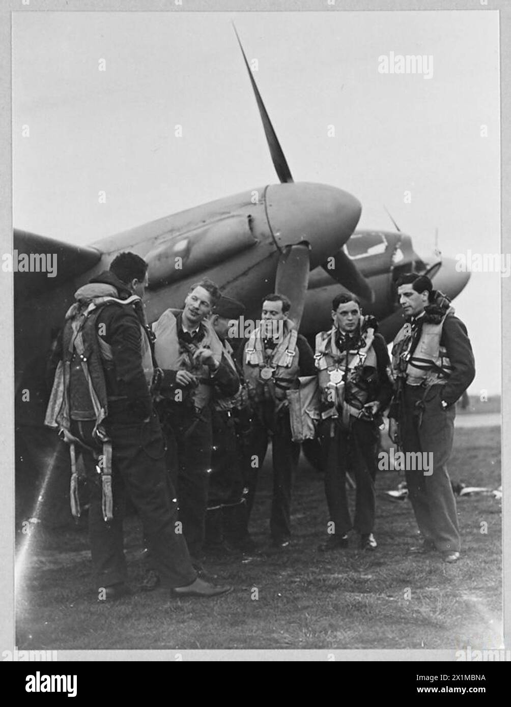 Pilots and navigators of No. 105 Squadron of the RAF are shown together ...