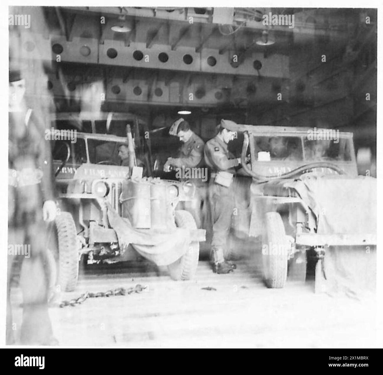 Jeeps from the Army Film and Photo Section are loaded onto landing ...