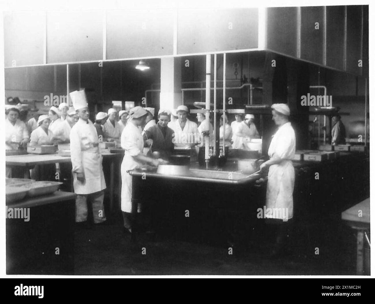 A.T.S. cooks are shown working in the main kitchen of a fortification ...