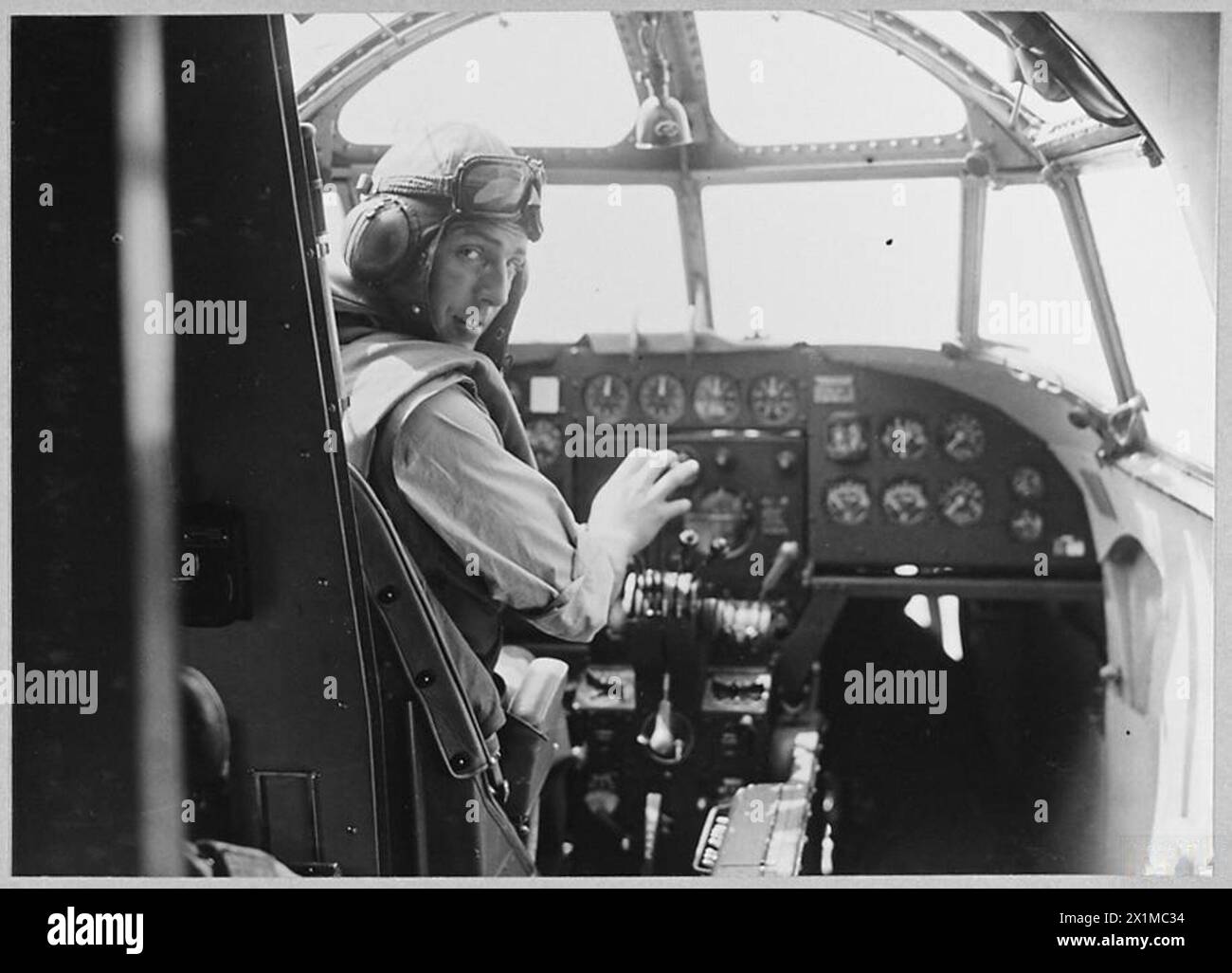 A Flight Leader pilots a Hudson aircraft over Heligoland, checking aft ...