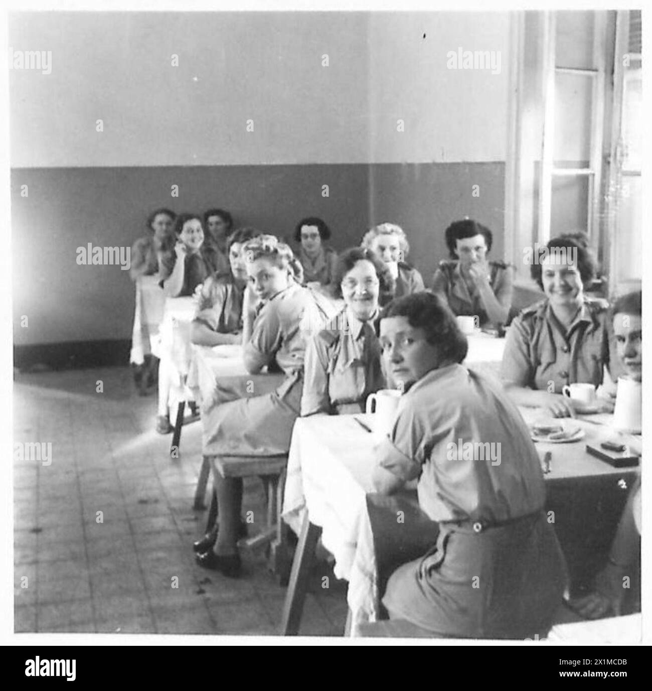 Women of the British Army Auxiliary Service are shown in the mess room ...