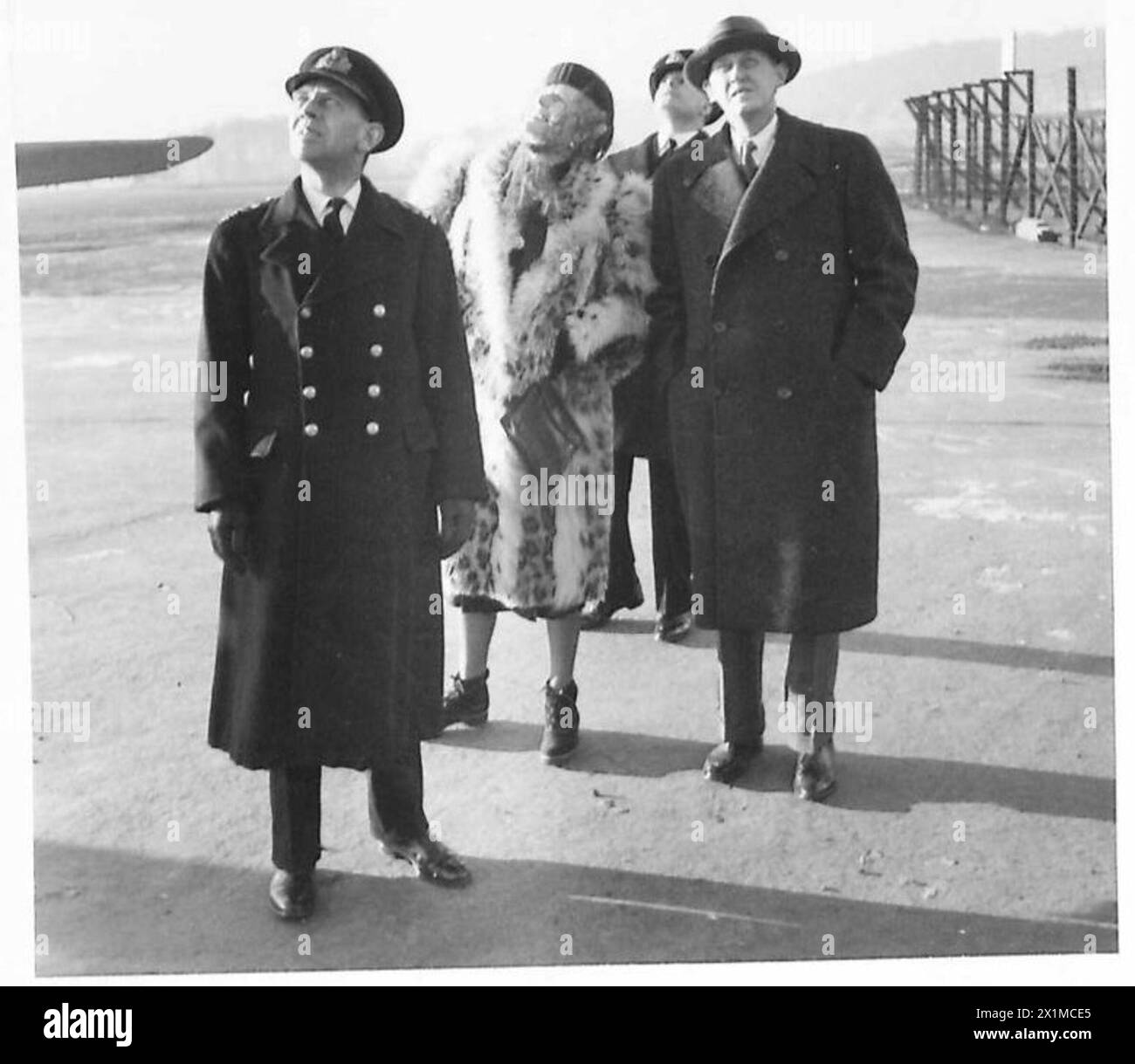Mrs. Churchill and Mr. Harry Hopkins observe a flying demonstration ...
