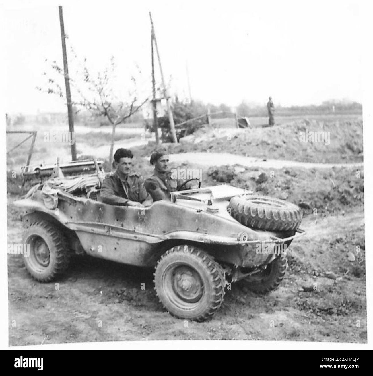 Two New Zealand soldiers with a captured German amphibious car near ...