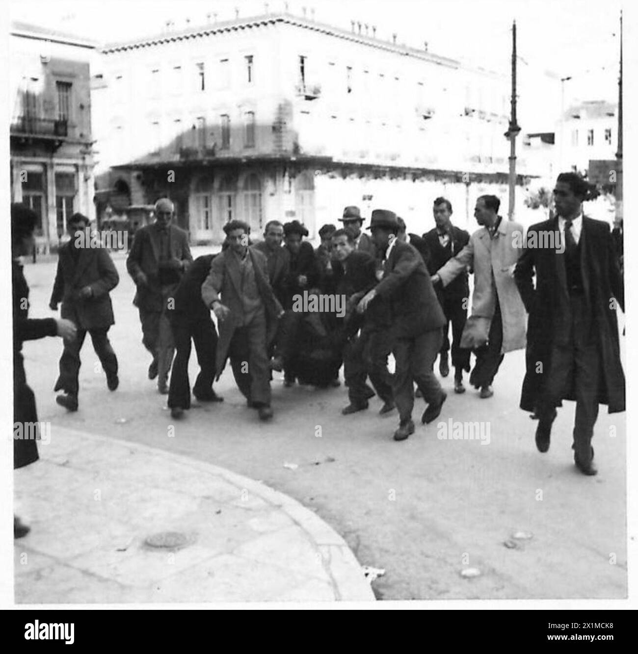 GREECE : RIOTS IN ATHENS - Carrying away the corpse of a victim of the ...