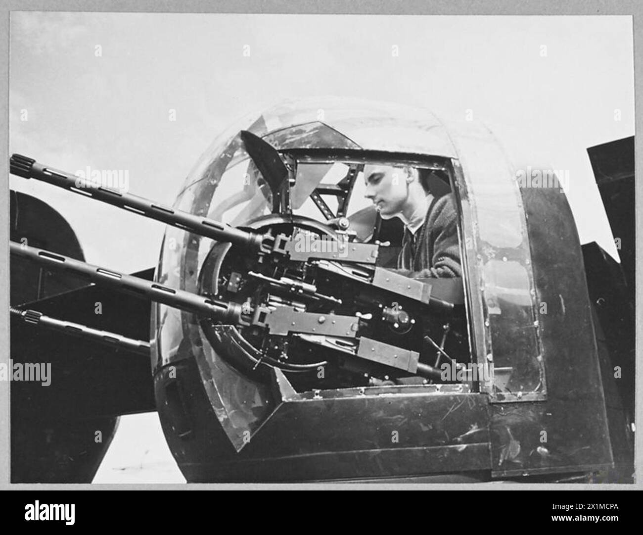 RAF armourer inspects and maintains the tail guns of a Halifax bomber ...