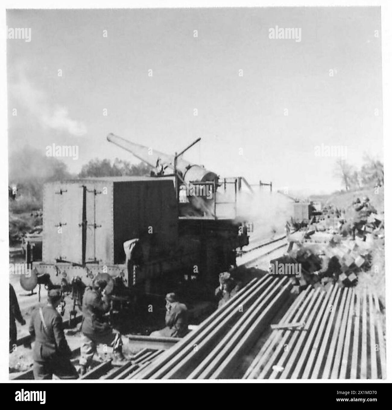 A railway gun operated by the Fifth Army is shown firing in Italy ...