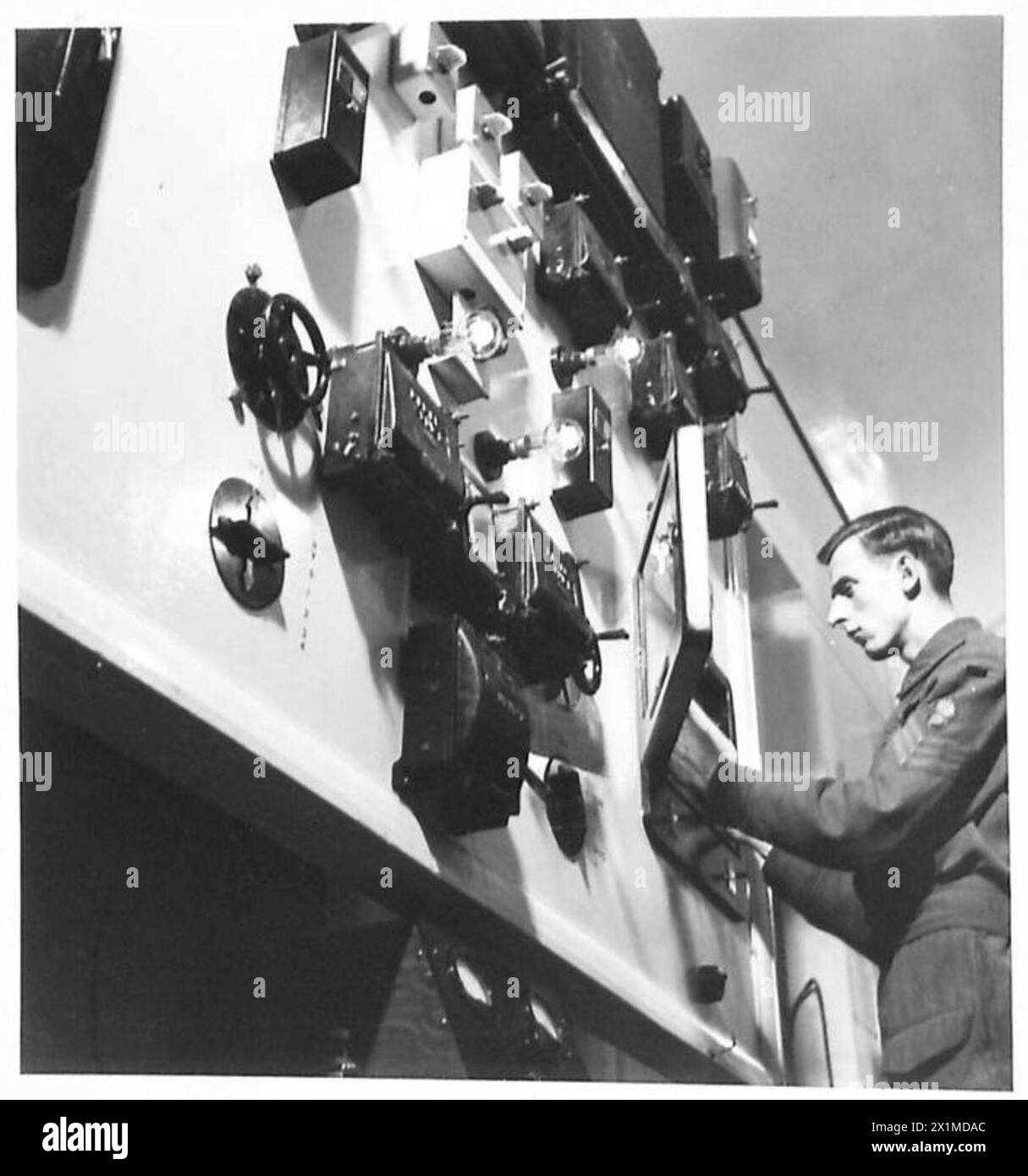 Sgt. Jackson, Royal Engineers, examines a control panel at the Army Blood Transfusion Service ...