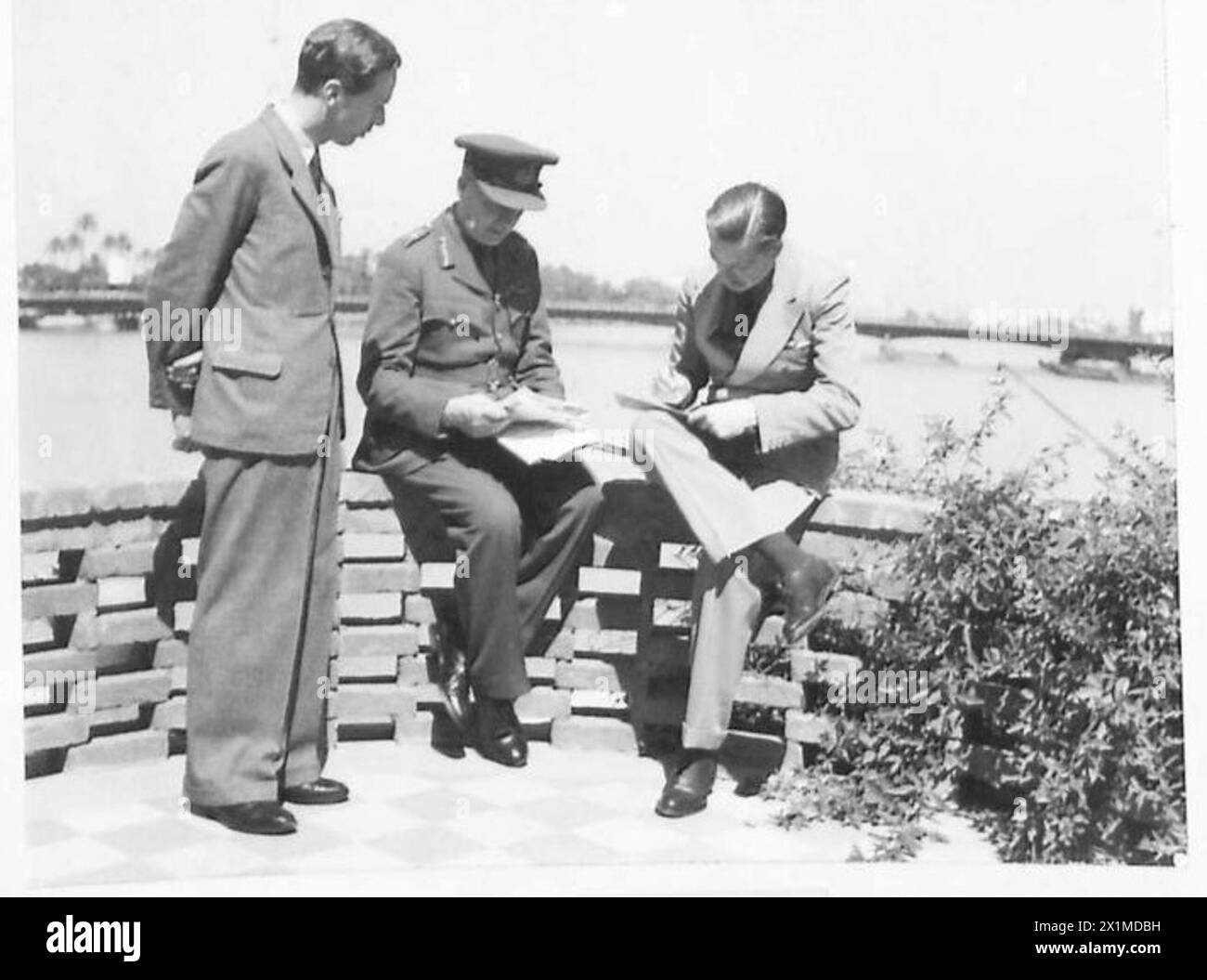 General Sir John Dill and Mr. Eden are pictured on a terrace observing ...