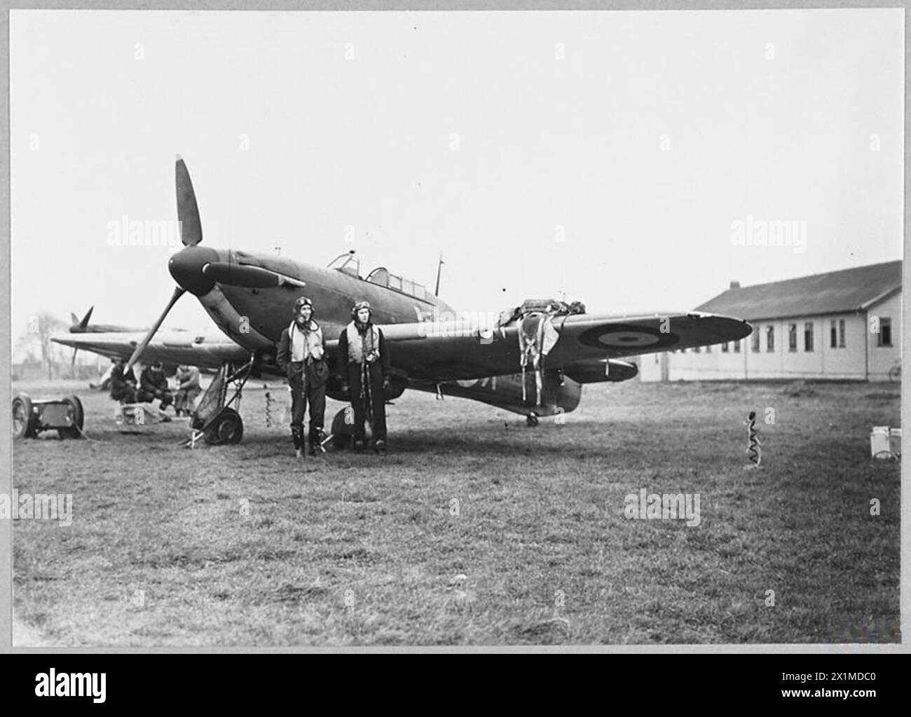 Canadian pilots of the RAF readiness flight prepare a Hurricane ...