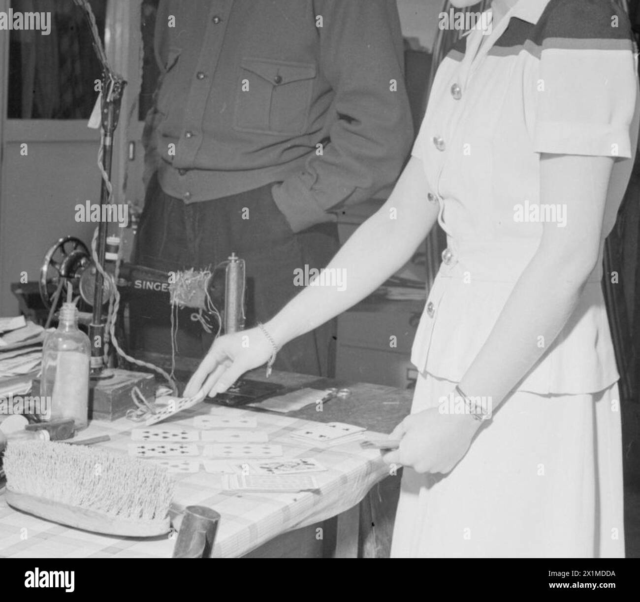 Actress Muriel Pavlow plays the card game 'Patience' while waiting for ...