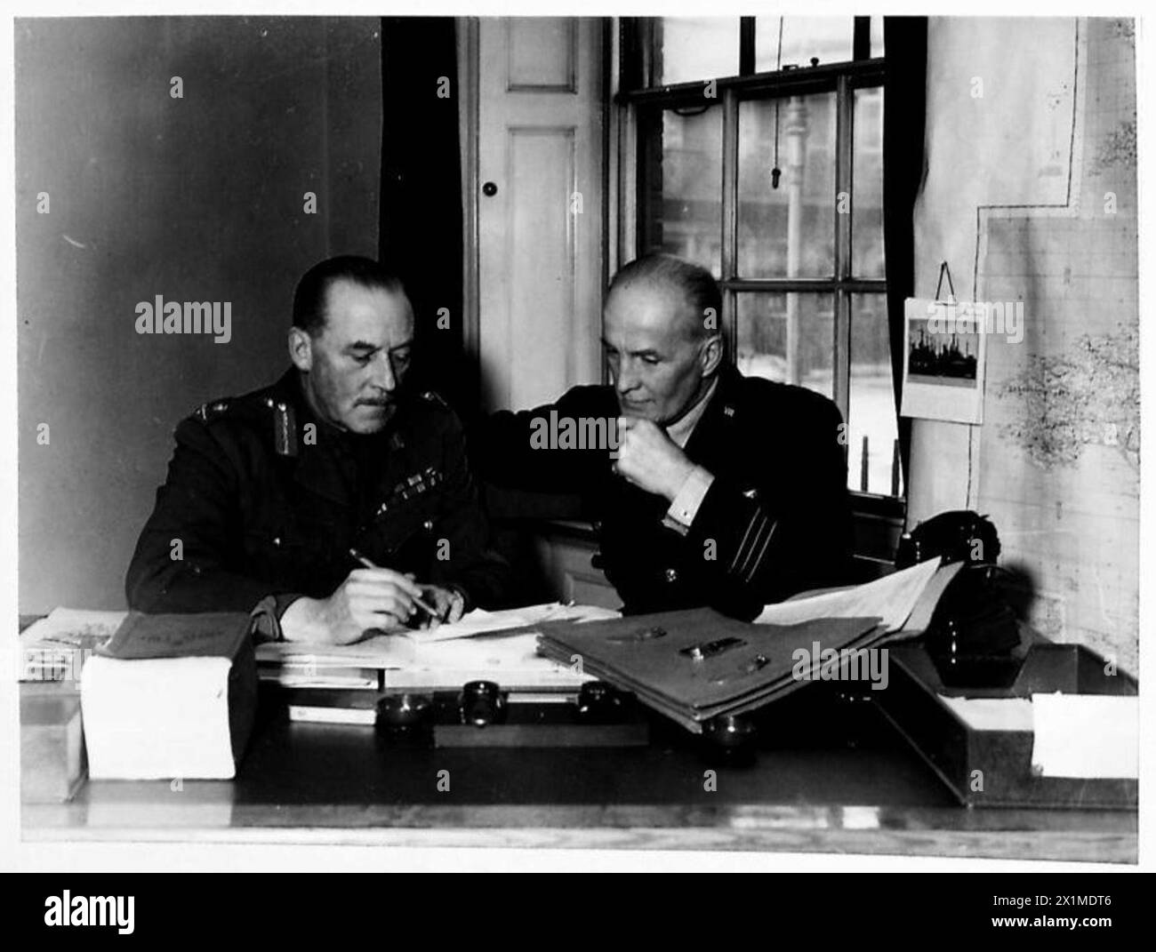 AIRFIELD DEFENCE CHIEF BEGINS WORK - Major-General Liardet with one of ...