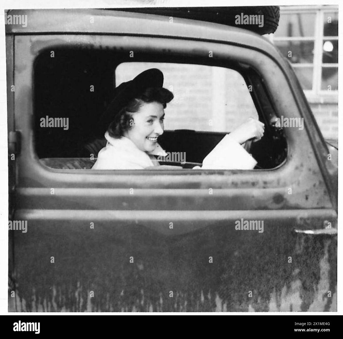 A civilian woman drives a utility car at the Central Ordnance Depot ...