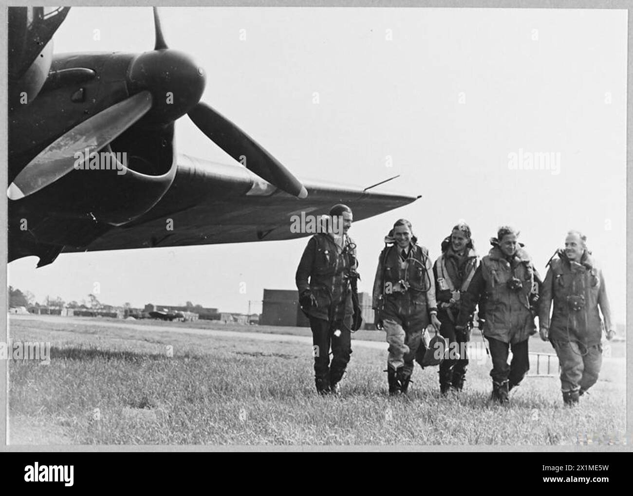 FROM R.A.F. BOMBER COMMAND STATIONS IN ENGLAND - The crew walk round to ...