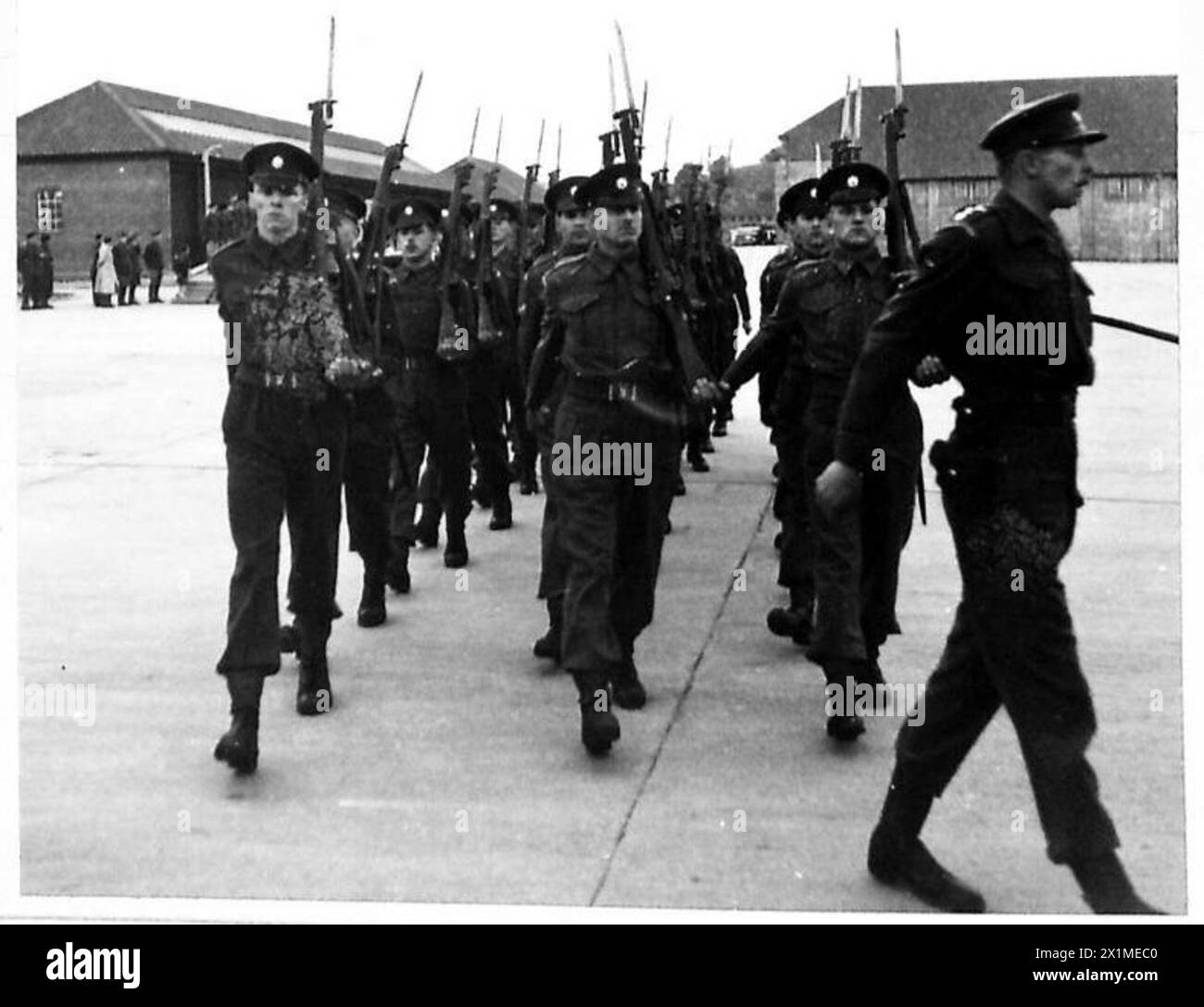 Troops of the Guards Armoured Division march past the King, Queen, and ...