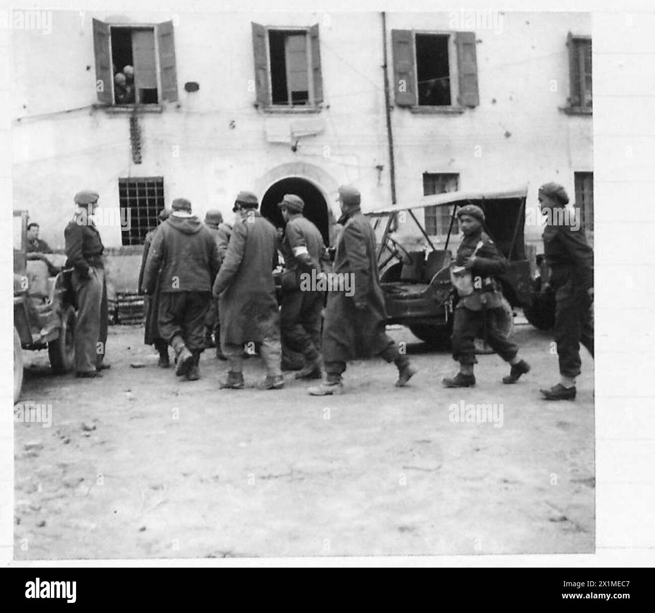 German prisoners of war are escorted by Gurkha soldiers following an ...