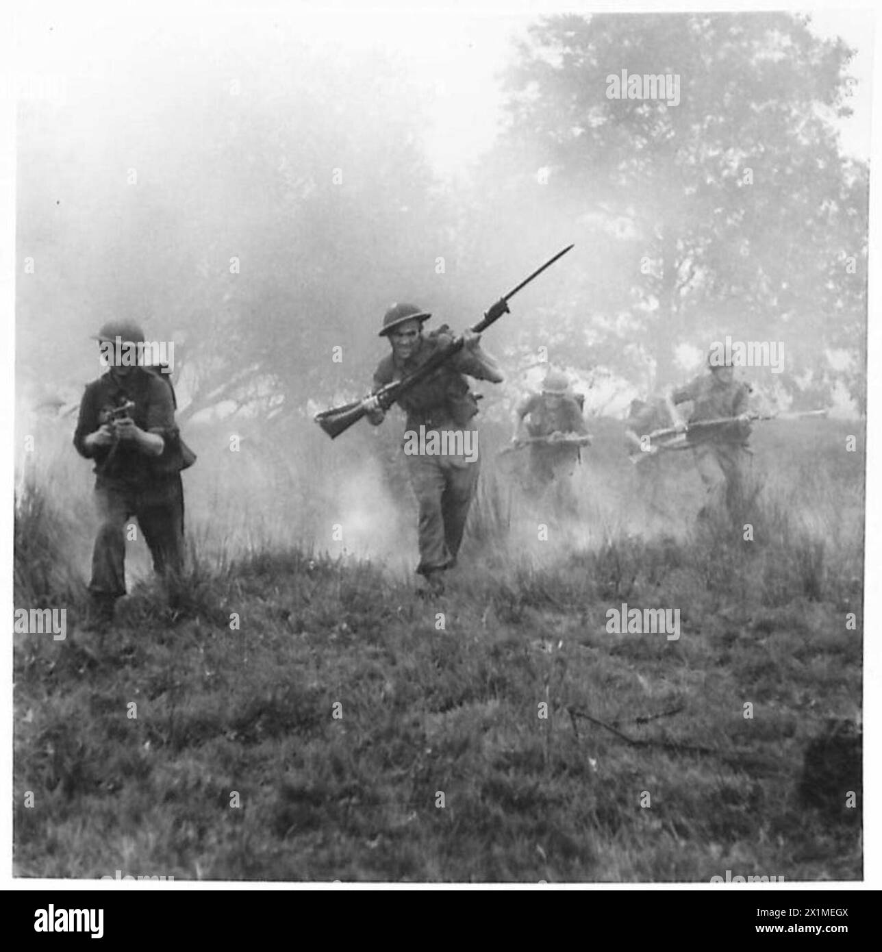 BATTLE TRAINING - Soldiers advance through a smoke screen towards their ...