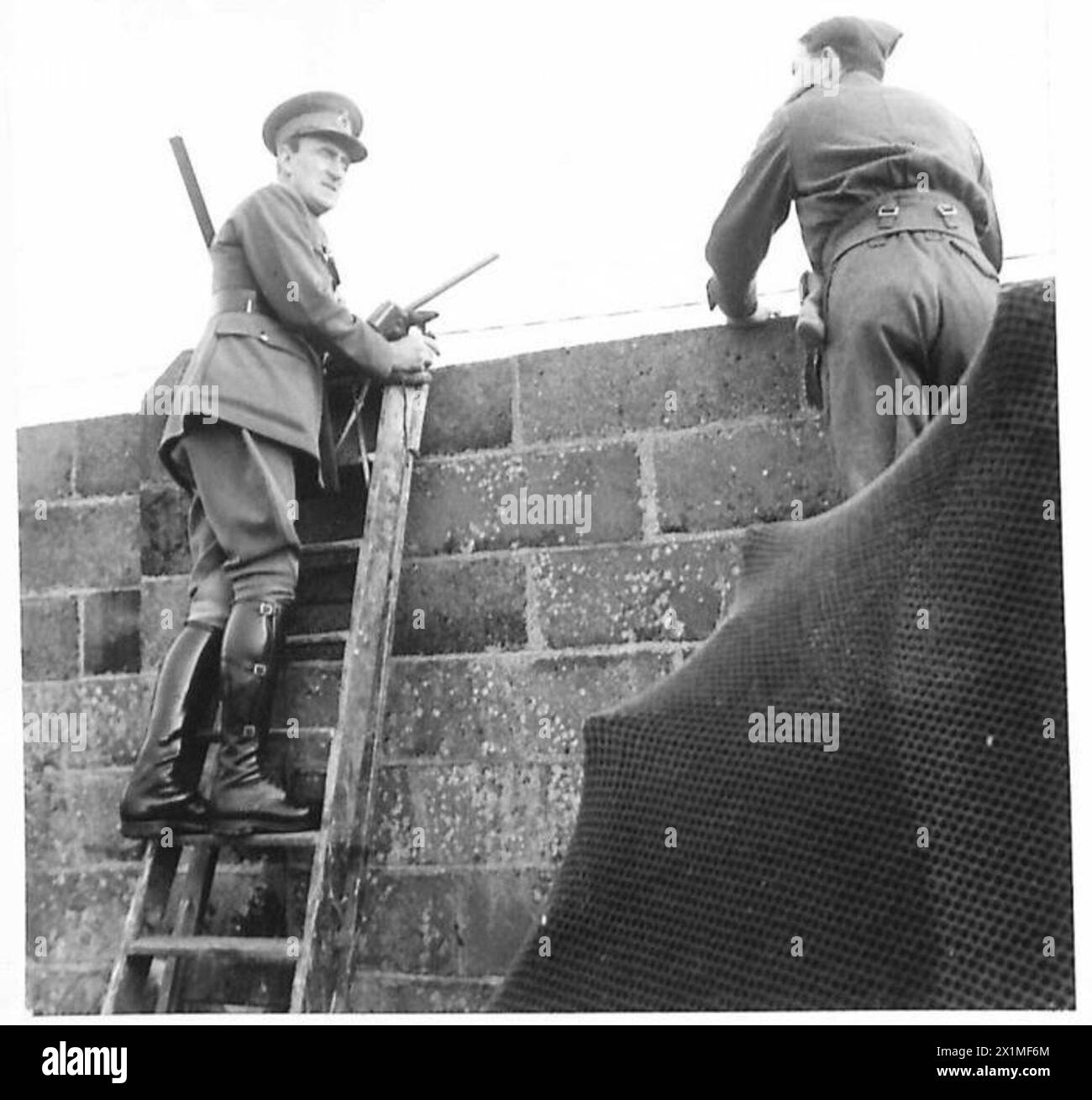The Commander-in-Chief observes mortar fire effects from a ladder over ...