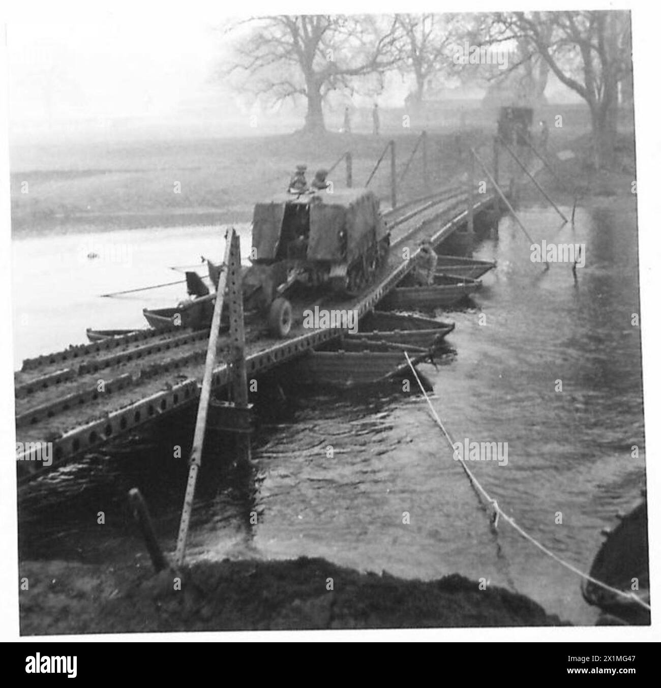 Crews of a British Army anti-tank regiment operate guns while crossing ...