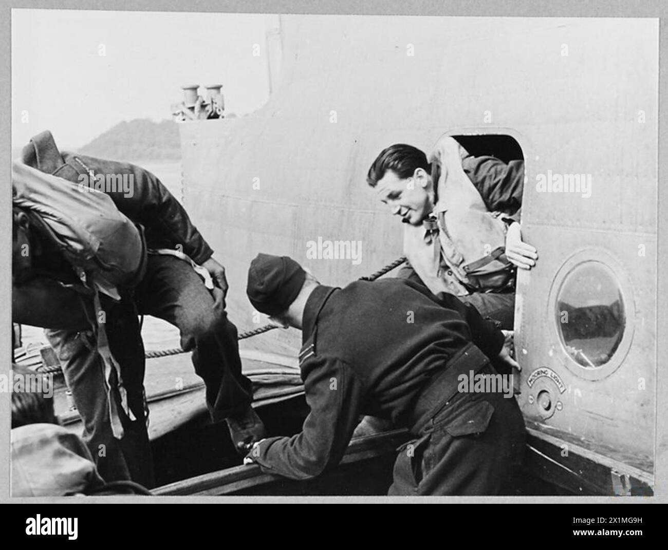 RAF aircrew from a rescued Whitley bomber climb from a Sunderland ...
