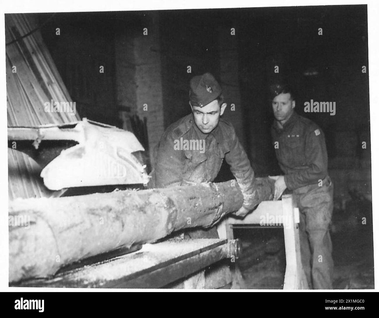 AN ARMY TIMBER YARD - A log being sawn into planks at the saw mills ...