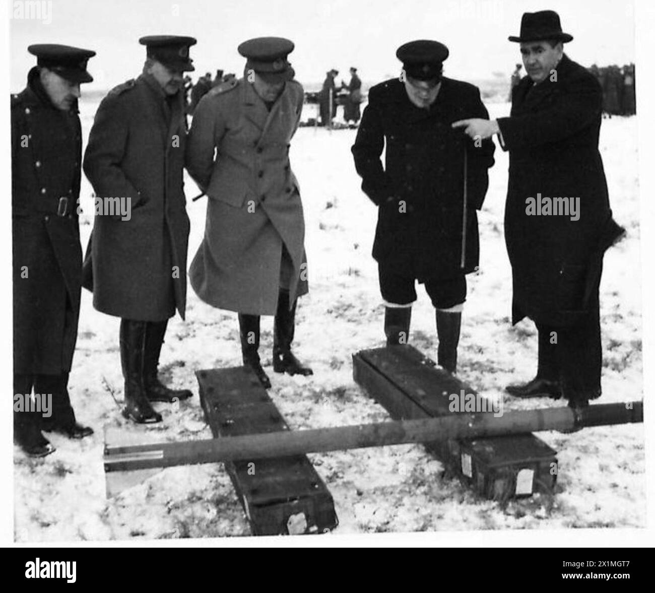 Prime Minister Winston Churchill observes ammunition during a ...