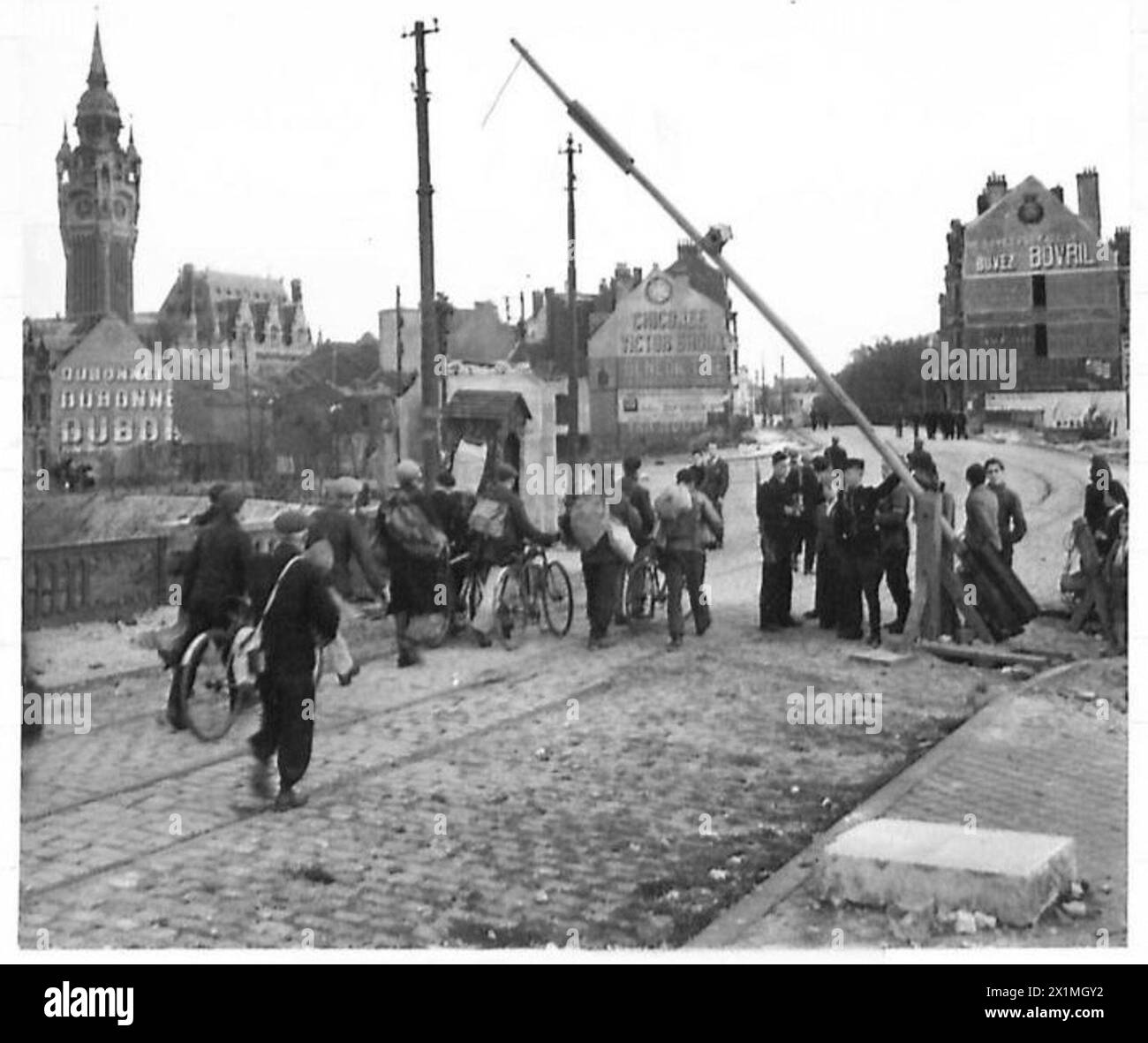 French civilian dock-workers are seen passing through a barrier in the ...