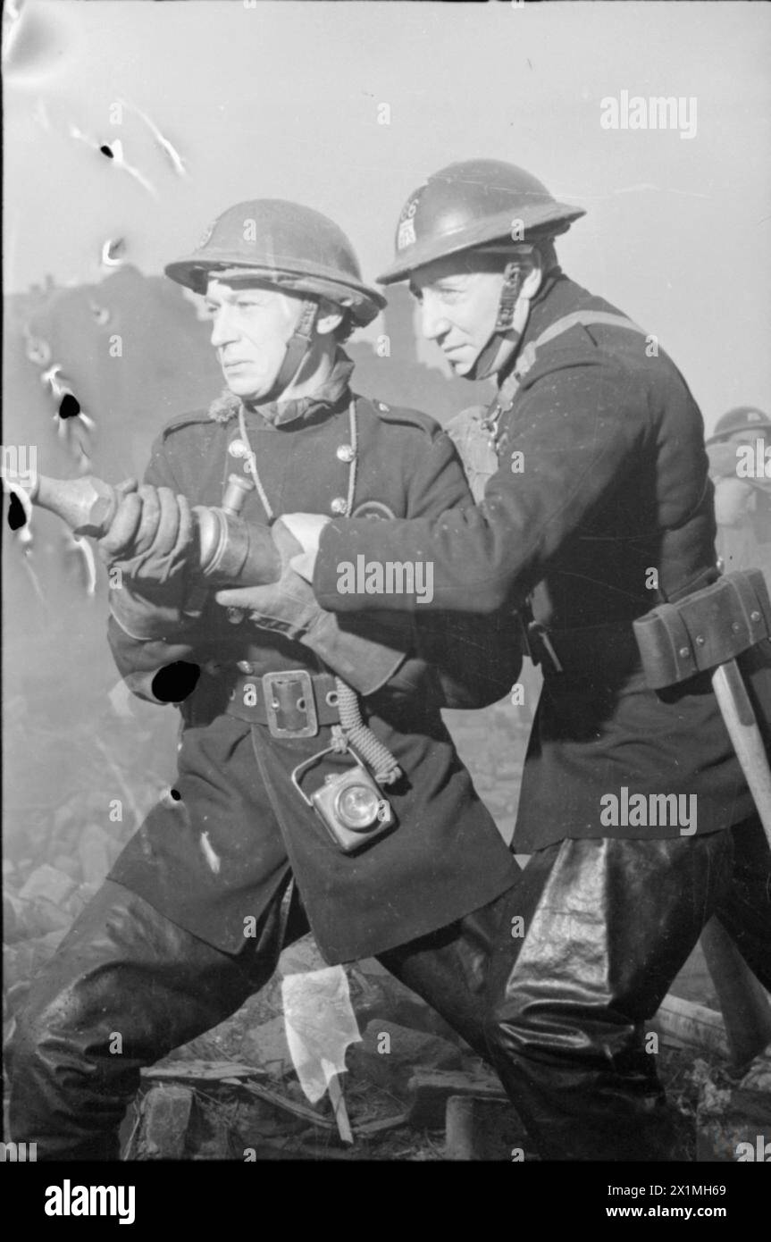 Auxiliary Firemen Richard Southern and R.H. Betts work together to ...