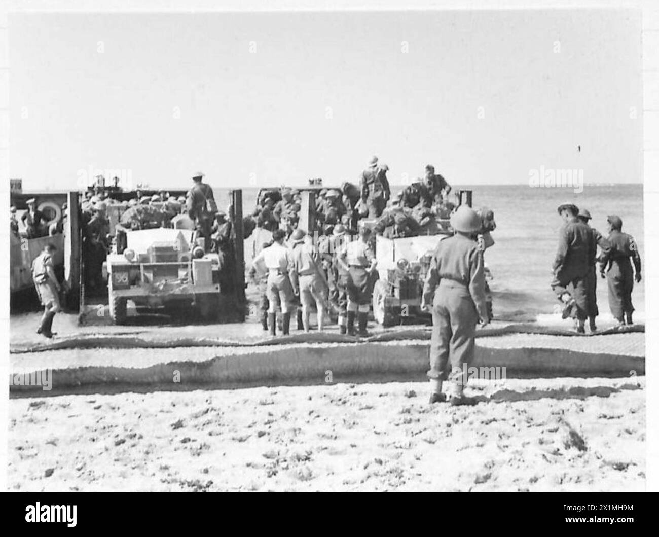 COMBINED OPERATIONS EXERCISE - Motor transport being driven off an M.L ...