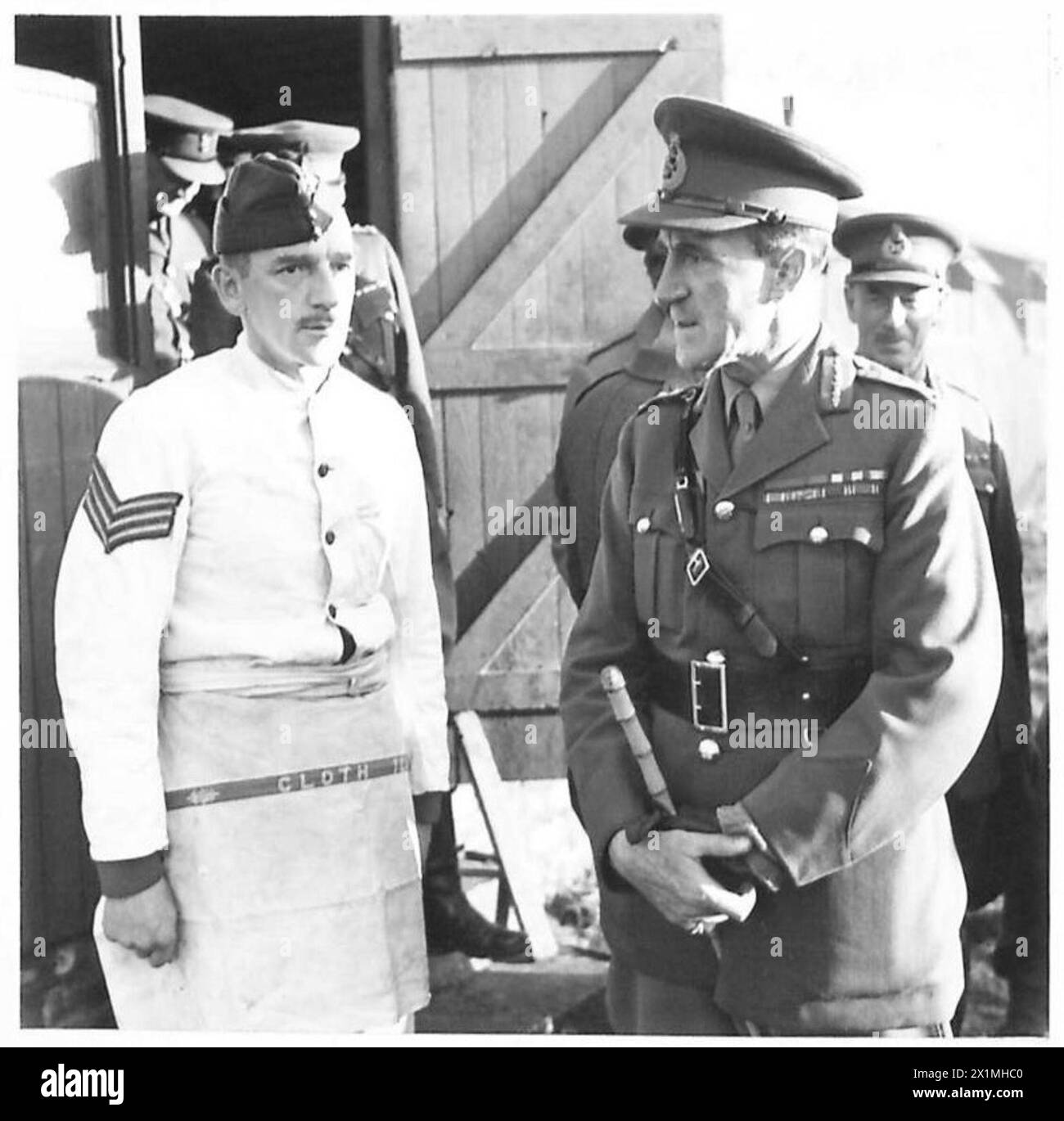 The Commander-in-Chief of Home Forces speaks with Sergeant Cook during ...