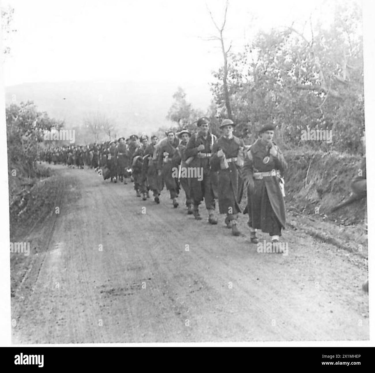 Scots Guards of the 201 Brigade, Fifth Army, are shown advancing along ...
