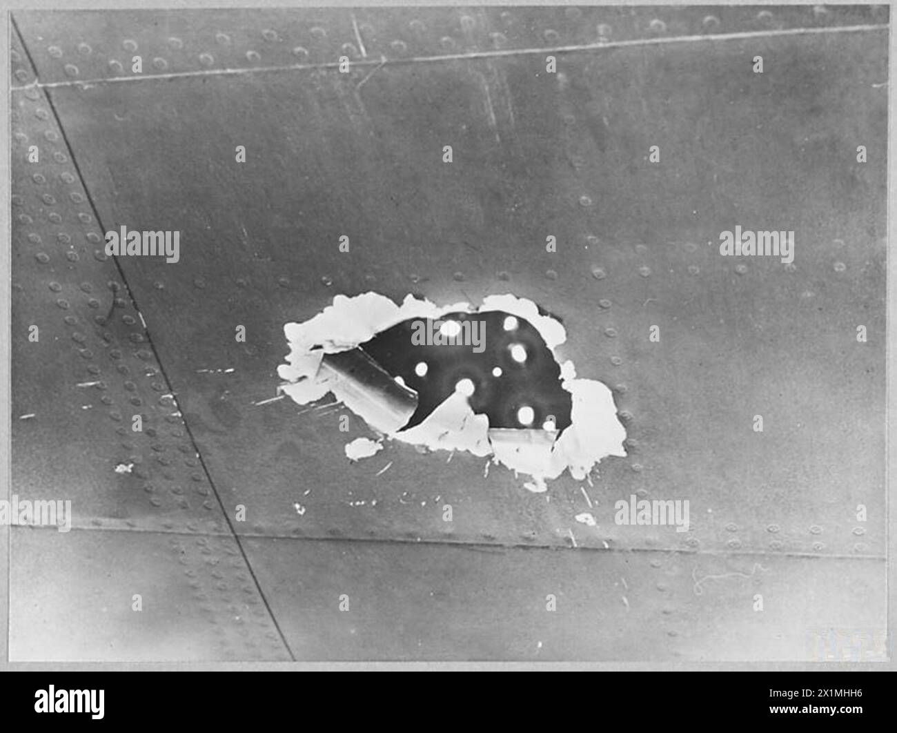 DAMAGE TO "HUDSON AIRCRAFT" BY "FLAK" - Photographs show damage to ...