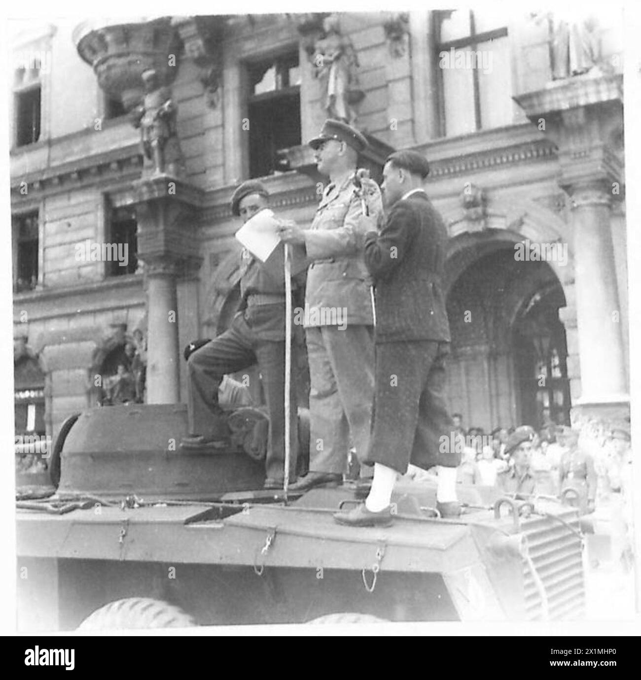 General Weir of the 46th Division addresses civilians from an armoured ...