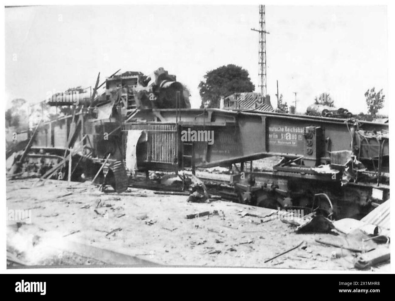 BOMB DAMAGE AT VIRE - A German gun on railway mounting in the railway ...
