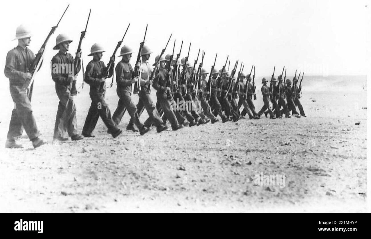 British Army infantry perform bayonet drills, advancing in line across ...