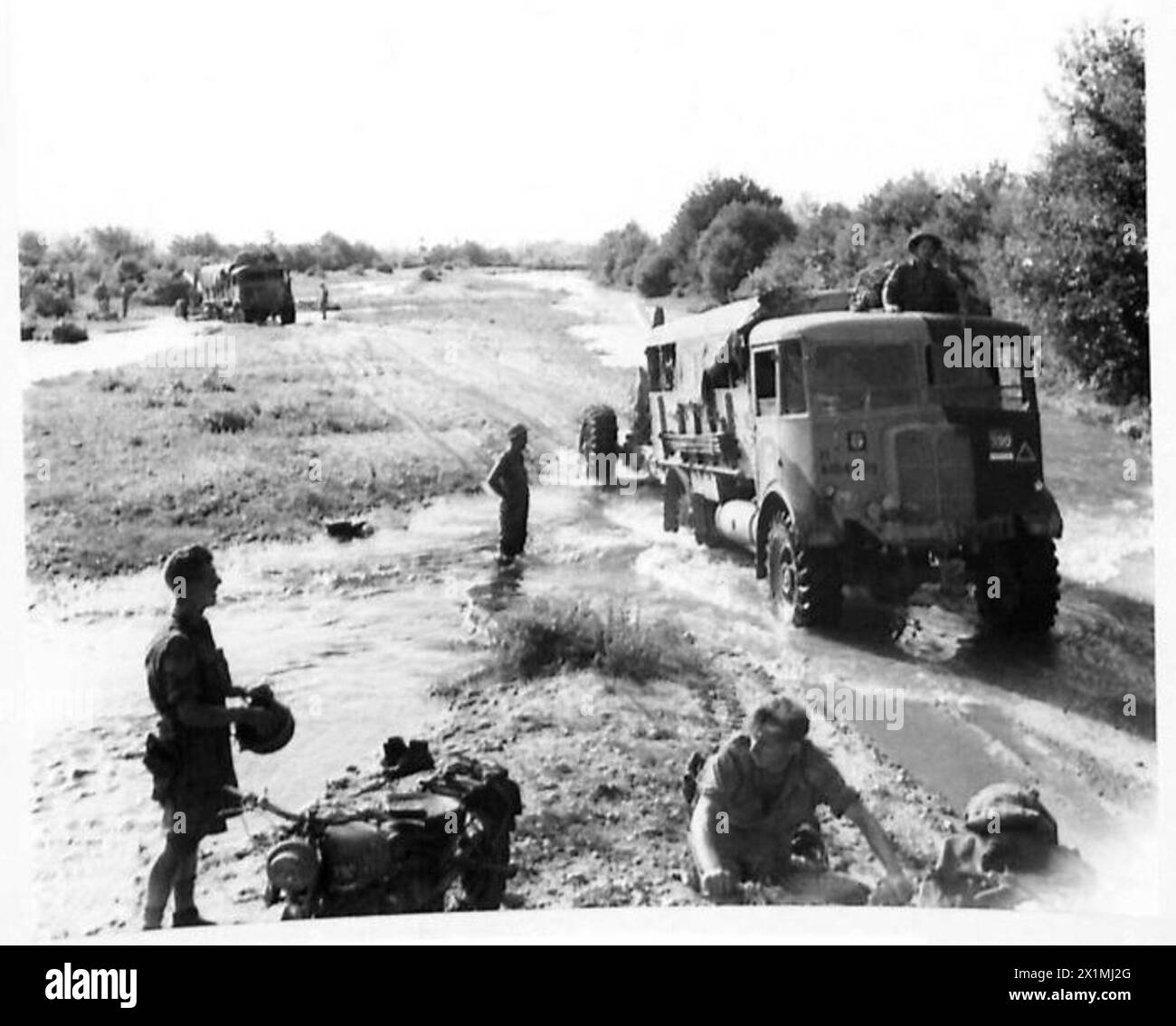 The 66th Medium Regiment of the British Army is seen fording a river at ...