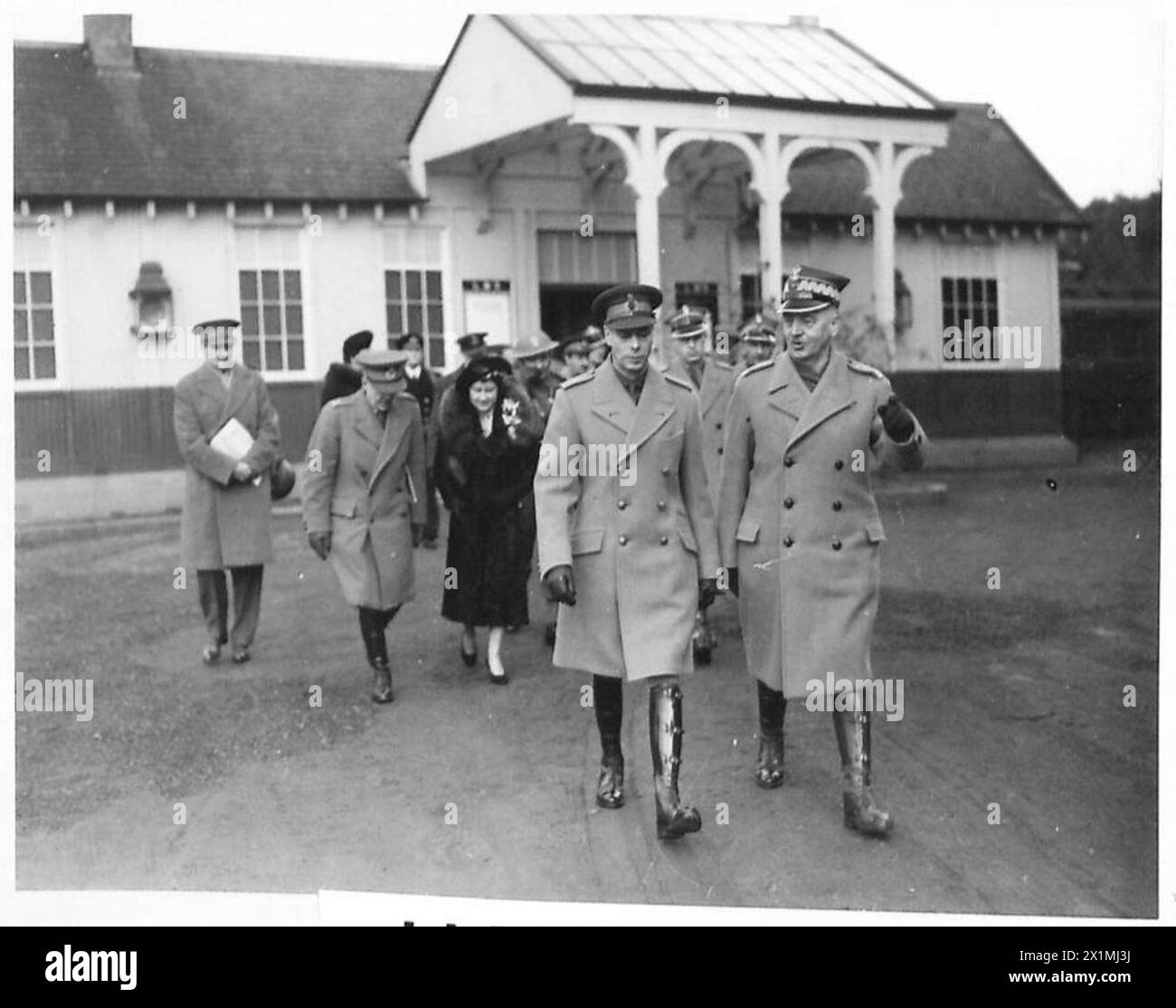 King George VI, accompanied by General Władysław Sikorski, arrives at a ...