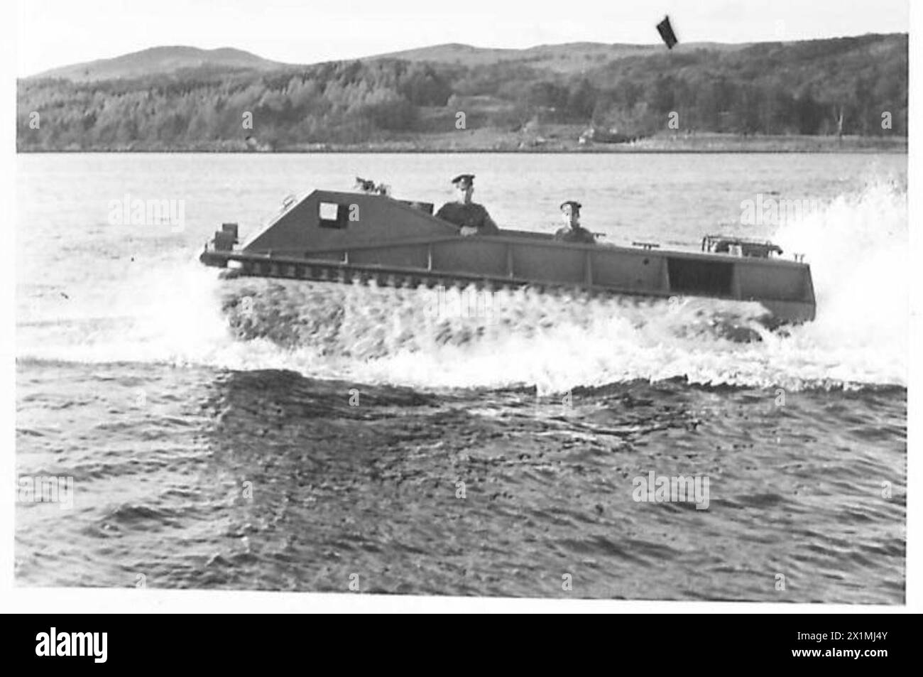 Amphibious vehicles known as 'Alligators' moving through water en route ...