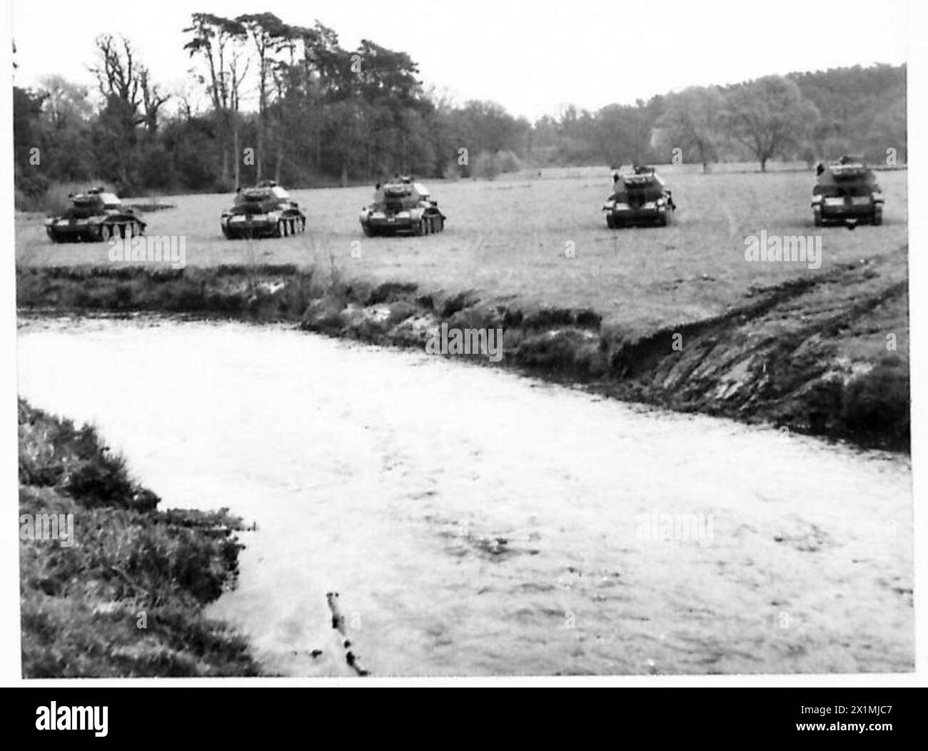 Cruiser tanks of the British Army clear woodland and prepare to cross a ...