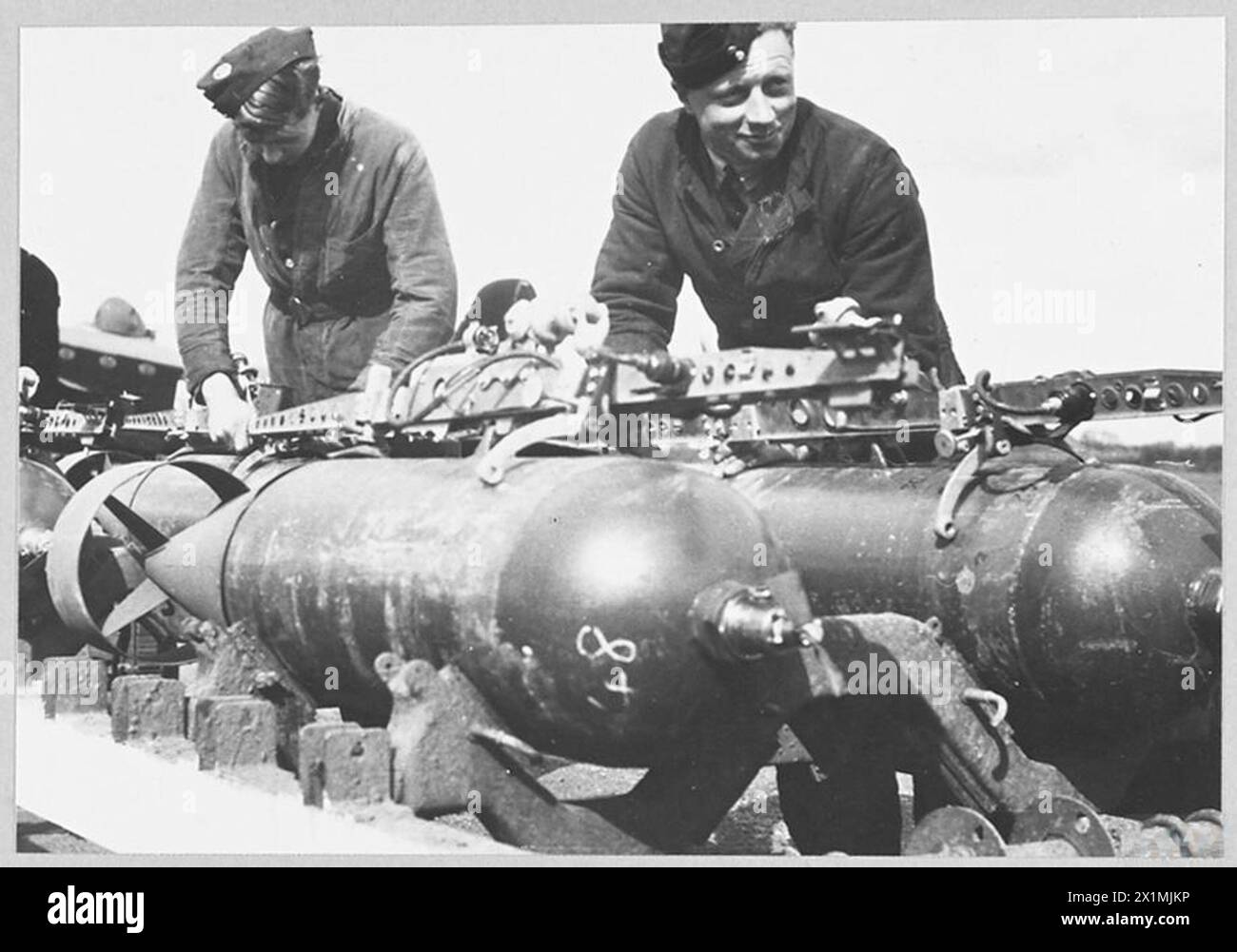 Ground crews prepare bombs for loading on Stirling aircraft at an RAF ...