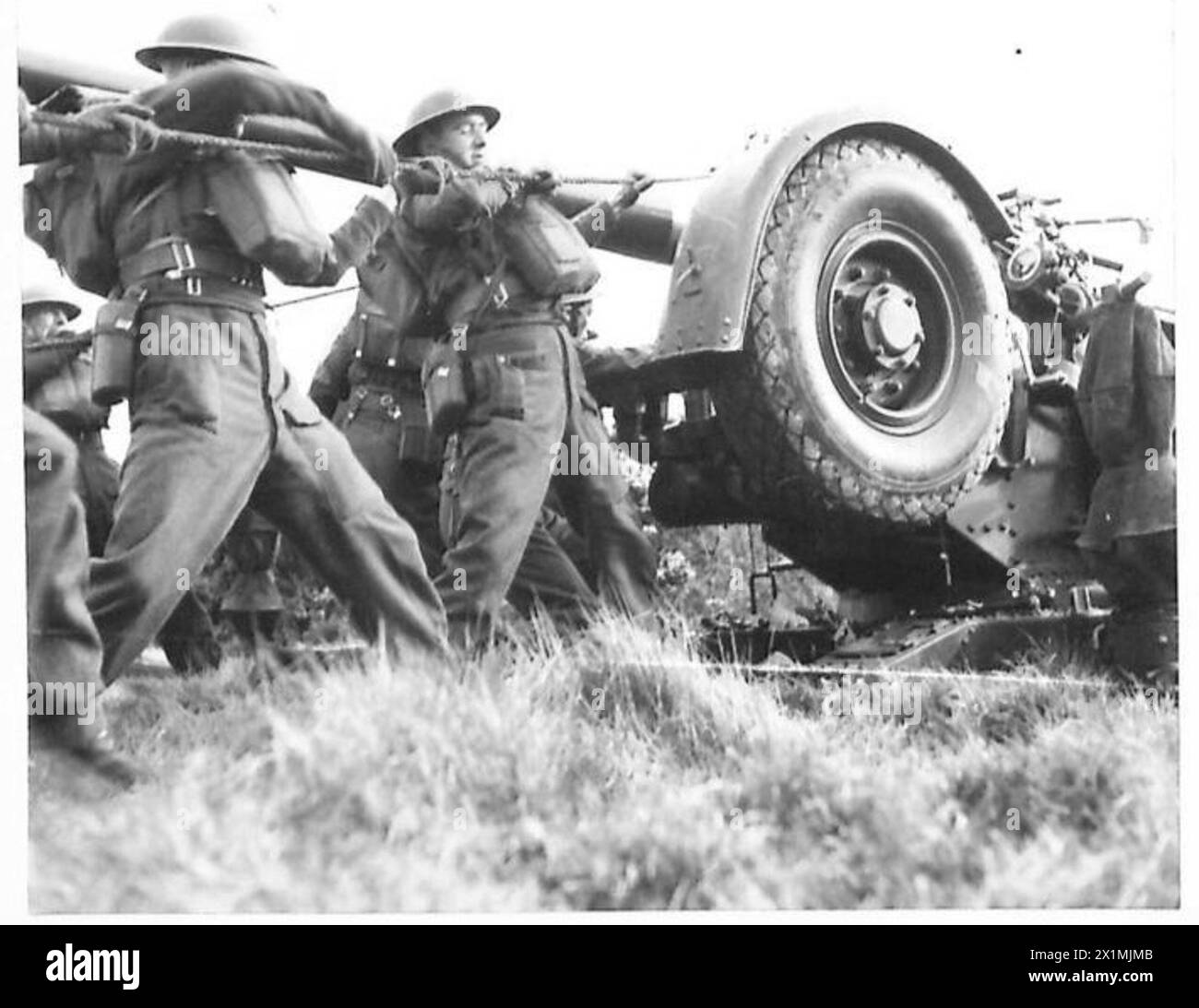 AA GUNNERS IN TRAINING - "Tug of War" with the guns. Gunners haul on ...