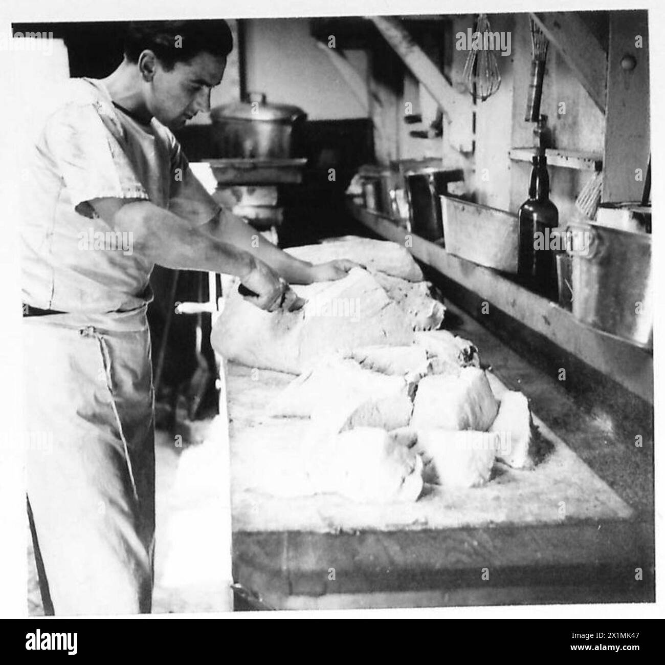 ON BOARD AN AFRICAN BOUND SHIP IN CONVOY - The ship's cook bakes bread ...
