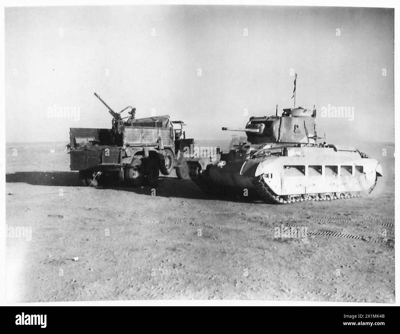 British Army tanks in the Western Desert pass captured materials, move ...