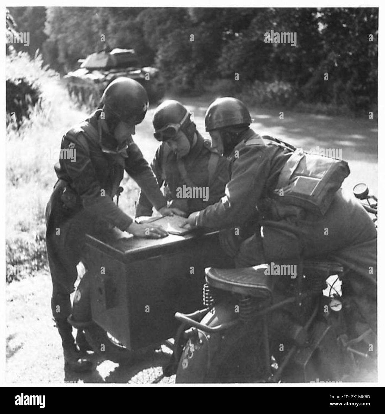 TANKS HAVE SPECIAL POLICE - Three of the police check a map reference ...