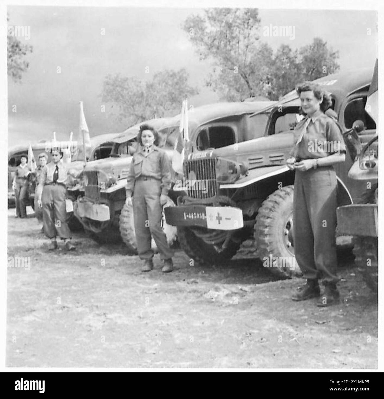 Female ambulance drivers of the Corps Feminin Croix Rouge stand ready ...