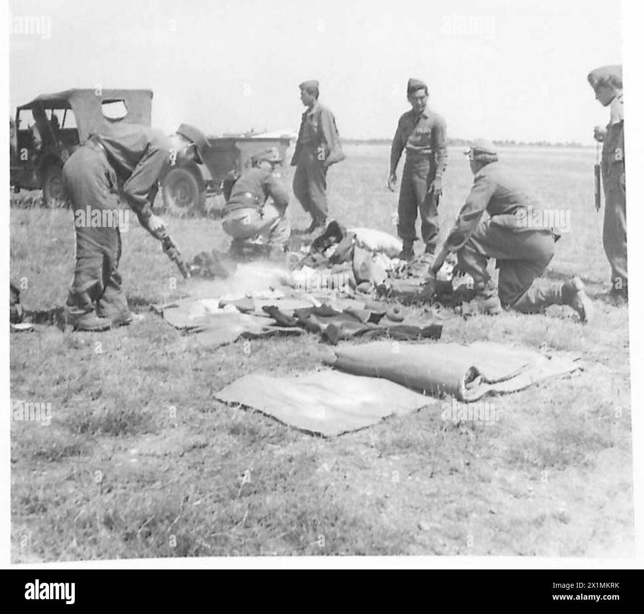 Newly-arrived German prisoners at a Fifth Army POW camp spread out ...